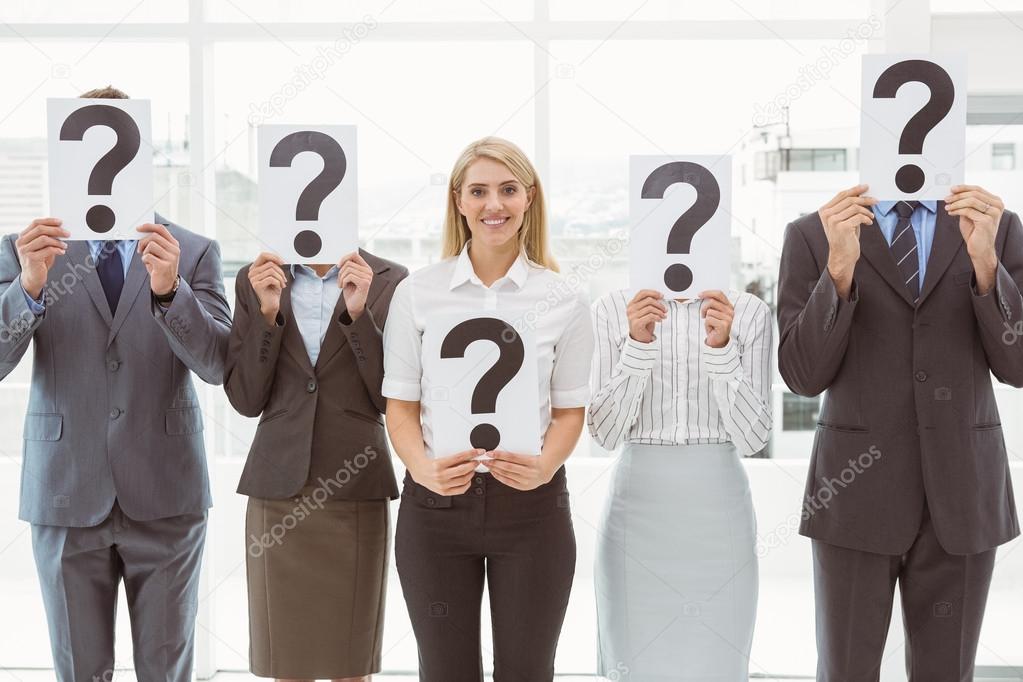 Business people holding question mark signs in office Stock Photo by ...
