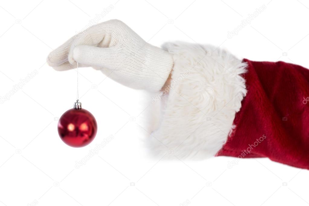 Santas hand is holding a Christmas bulb Stock Photo by ©Wavebreakmedia ...