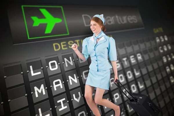 Pretty air hostess pulling suitcase Stock Photo by ©Wavebreakmedia 62510231