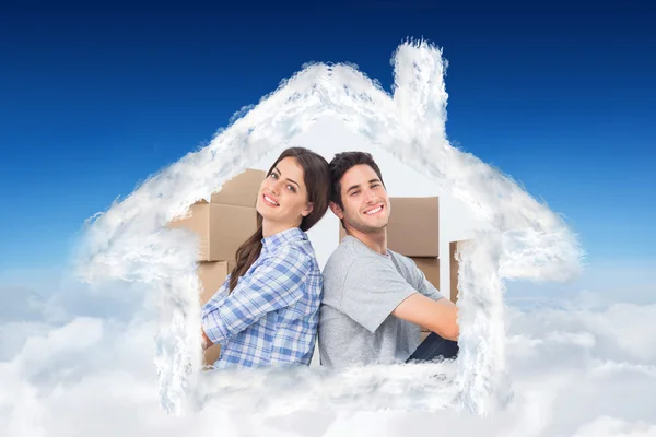 Happy couple sitting back-to-back - Stock Image - Everypixel