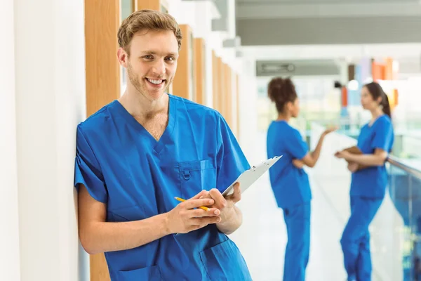 Medical student smiling at camera in hallway - Stock Image - Everypixel