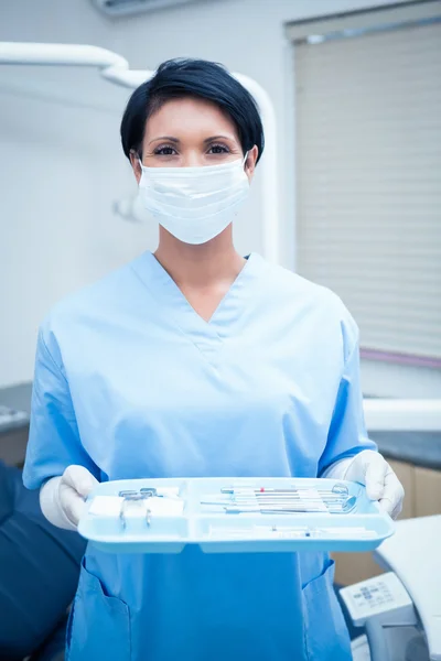 Female dentist wearing surgical mask and safety glasses Stock Photo by ...