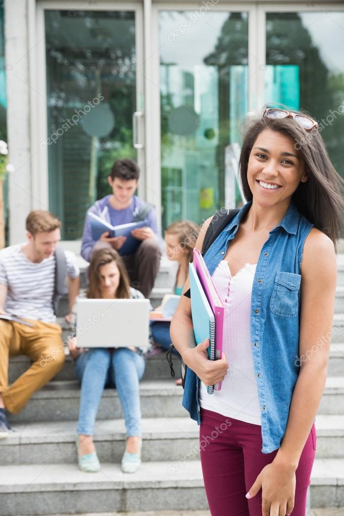 Pretty student smiling at camera outside Stock Photo by ©Wavebreakmedia ...