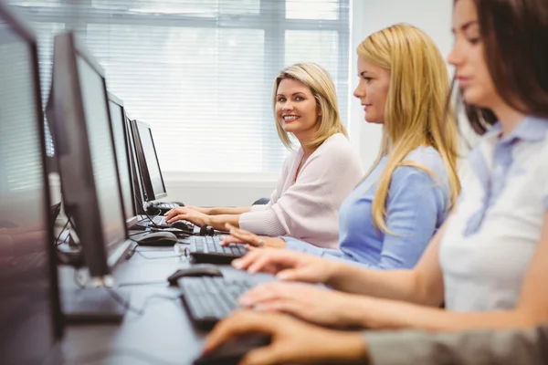 Smiling students using computer — Stock Photo © Wavebreakmedia #98083244