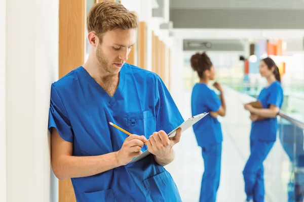 Medical student smiling at camera in hallway Stock Photo by ...