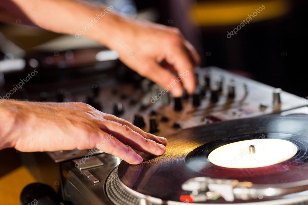 Cool dj spinning the decks Stock Photo by ©Wavebreakmedia 65280841