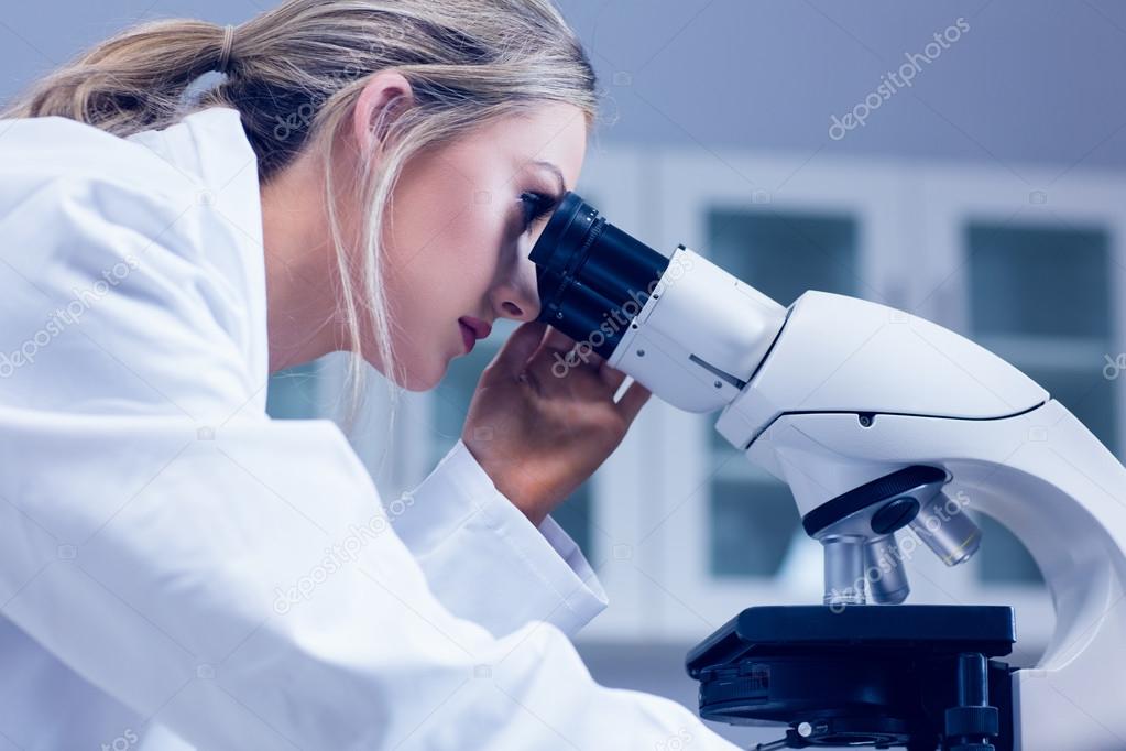 Science student looking through microscope in the lab Stock Photo by ...