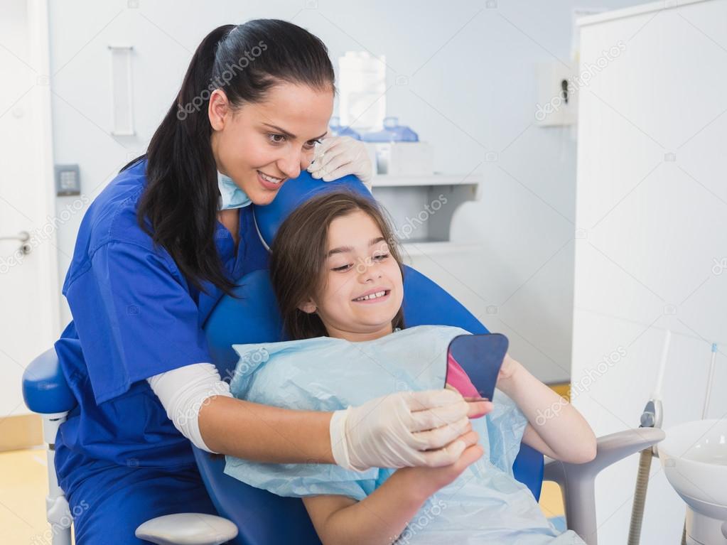 Dentist and young patient holding a mirror — Stock Photo ...
