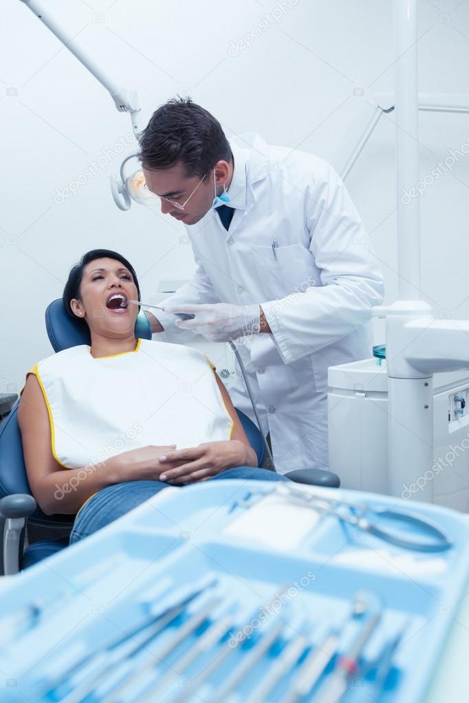 Male dentist examining womans teeth Stock Photo by ©Wavebreakmedia 65292103