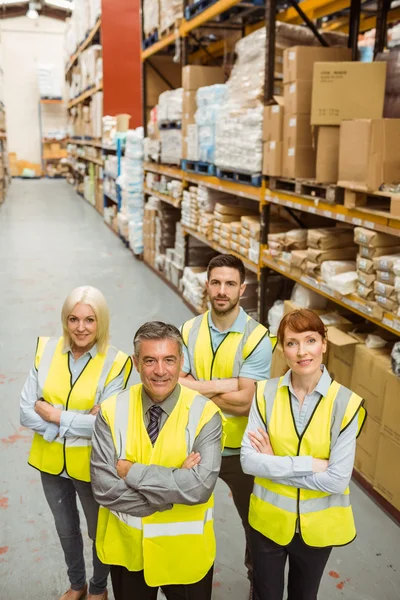 Smiling warehouse team with arms crossed Stock Photo by ©Wavebreakmedia ...