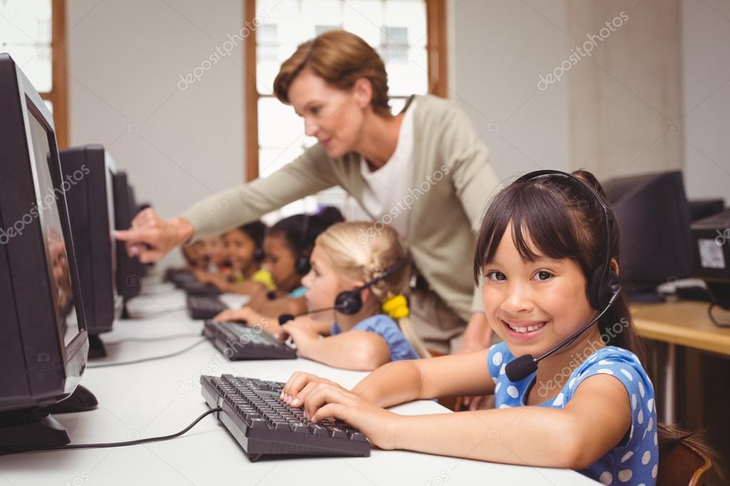 Cute pupils in computer class with teacher Stock Photo by ...