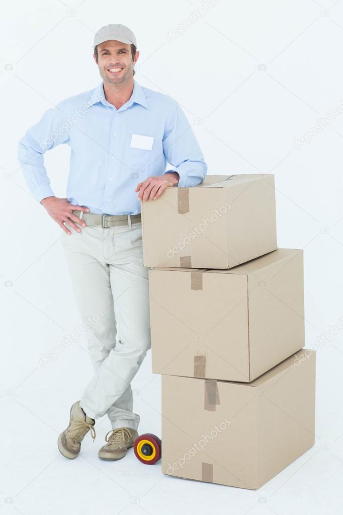Delivery man leaning on boxes Stock Photo by ©Wavebreakmedia 65553909