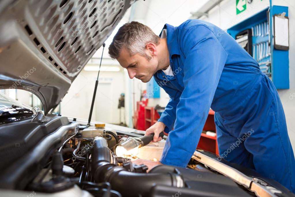 Mechanic examining under hood of car Stock Photo by ©Wavebreakmedia ...