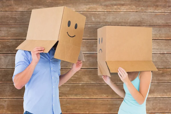 Couple wearing emoticon face boxes Stock Photo by ©Wavebreakmedia 68907157