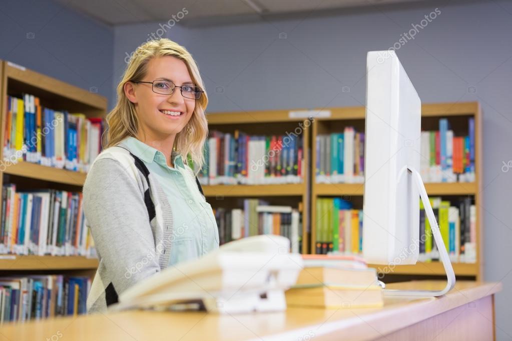Pretty librarian working in the library — Stock Photo © Wavebreakmedia ...