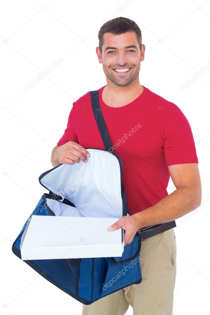 Delivery man removing pizza box from bag Stock Photo by ©Wavebreakmedia ...
