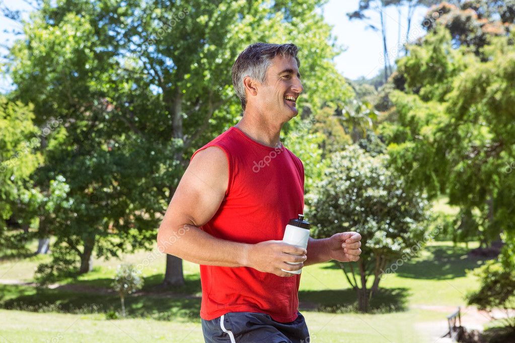 Fit man jogging in the park Stock Photo by ©Wavebreakmedia 68994883