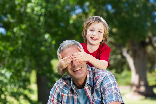 Boy hiding his fathers eyes with hands — Stock Photo © Wavebreakmedia ...