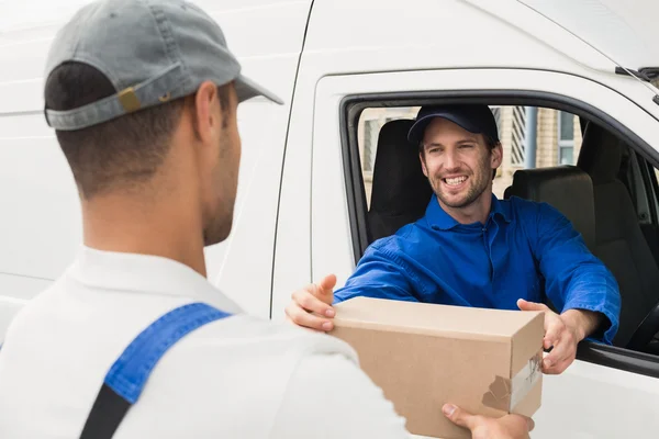 Delivery driver handing parcel to customer - Stock Image - Everypixel