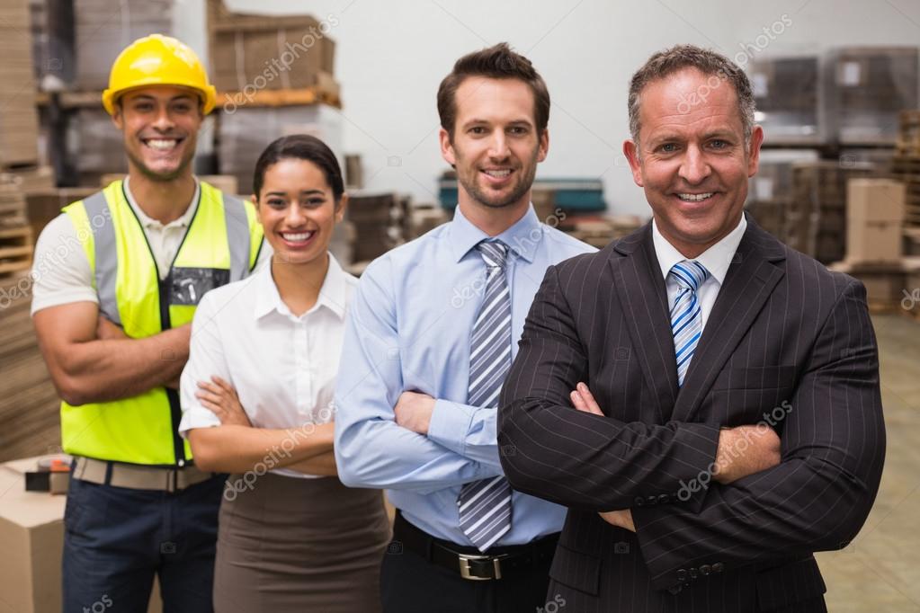 Warehouse team smiling at camera Stock Photo by ©Wavebreakmedia 69015069