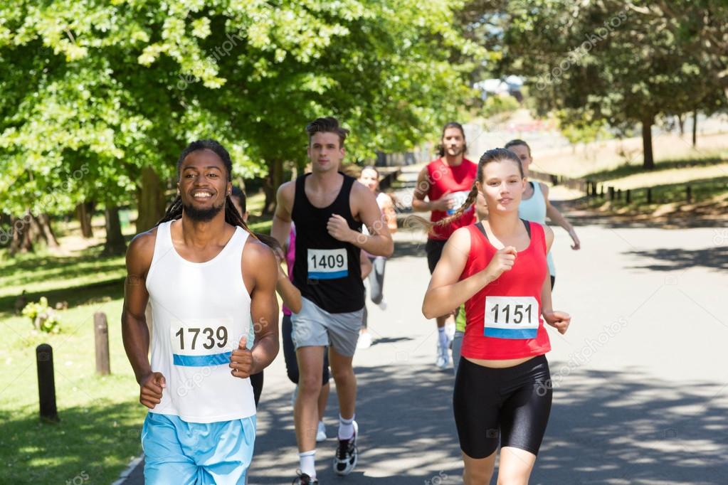 Happy people running race in park — Stock Photo © Wavebreakmedia #69021413