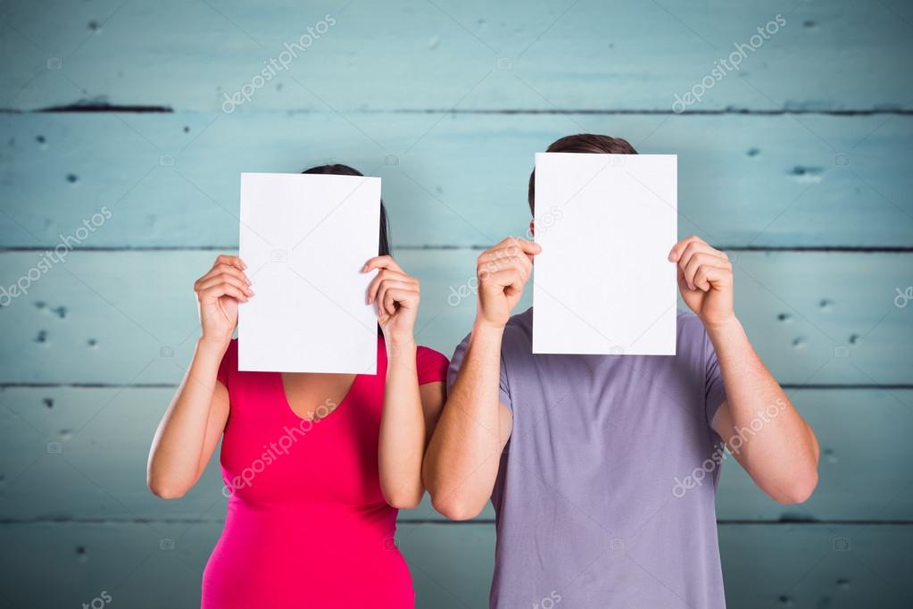 Couple covering faces with paper Stock Photo by ©Wavebreakmedia 69031937