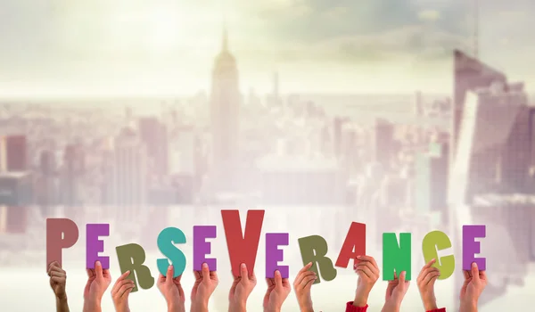 Hands showing perseverance against large window - Stock Image - Everypixel