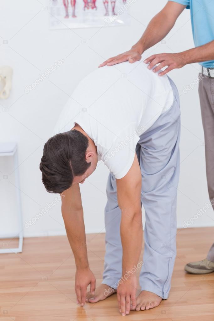 Doctor examining his patient back — Stock Photo © Wavebreakmedia #73270089