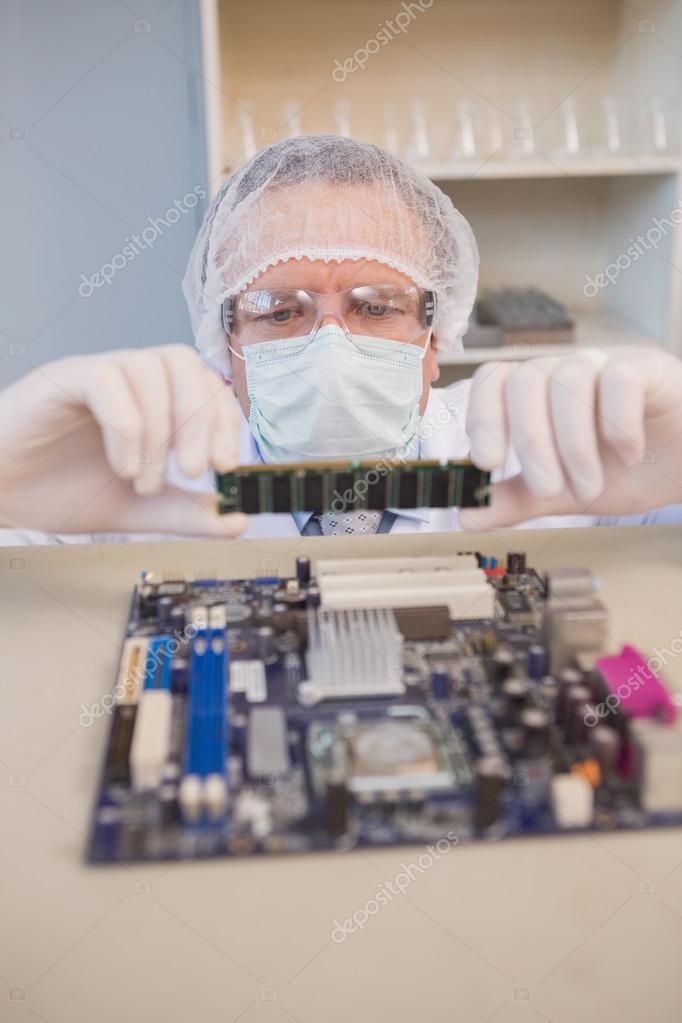 Engineer working on broken cpu Stock Photo by ©Wavebreakmedia 73287271