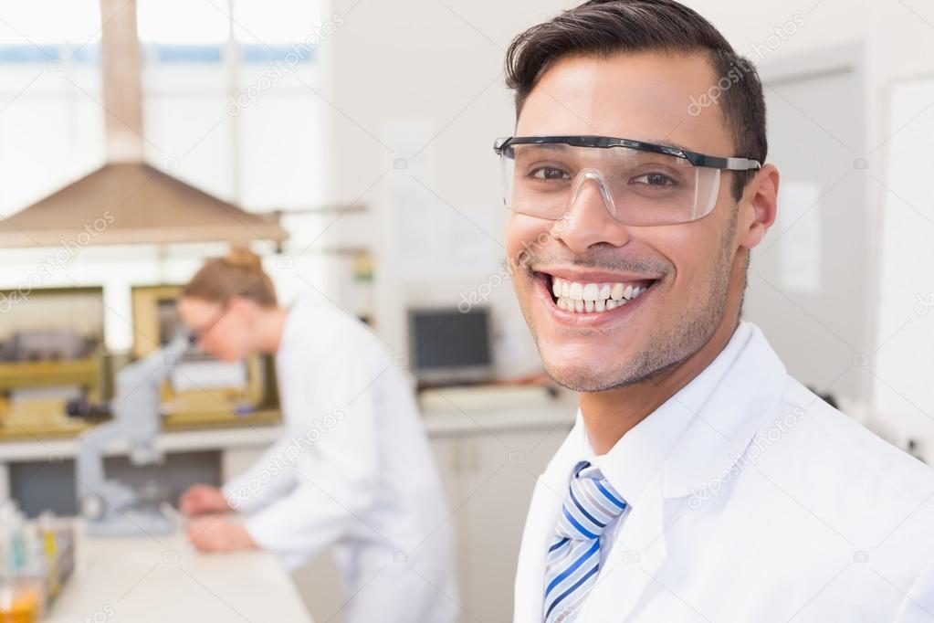 Happy scientist smiling at camera — Stock Photo © Wavebreakmedia #73290595 Happy scientist smiling at camera — Stock Photo © Wavebreakmedia #73290595