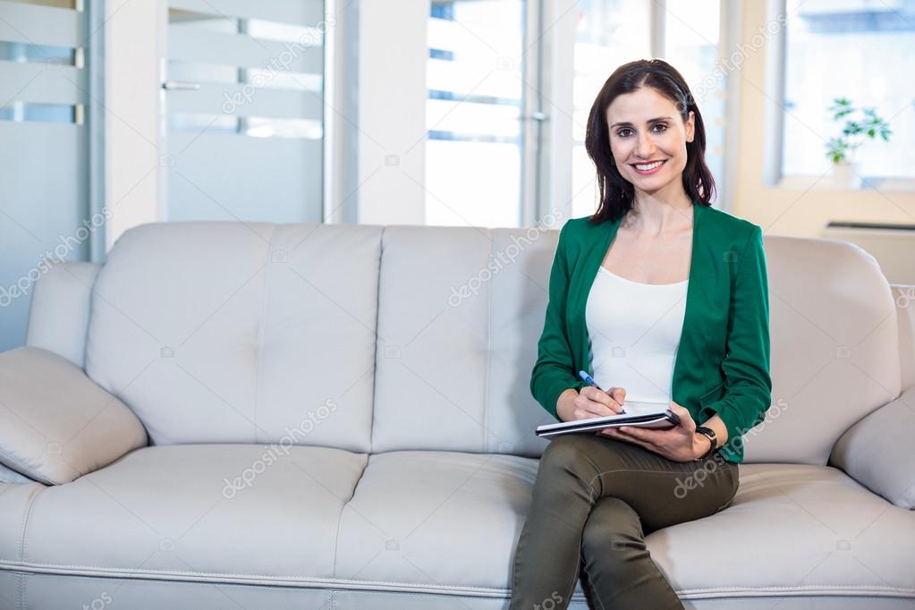 Psychologist sitting on the couch and taking notes Stock Photo by ...