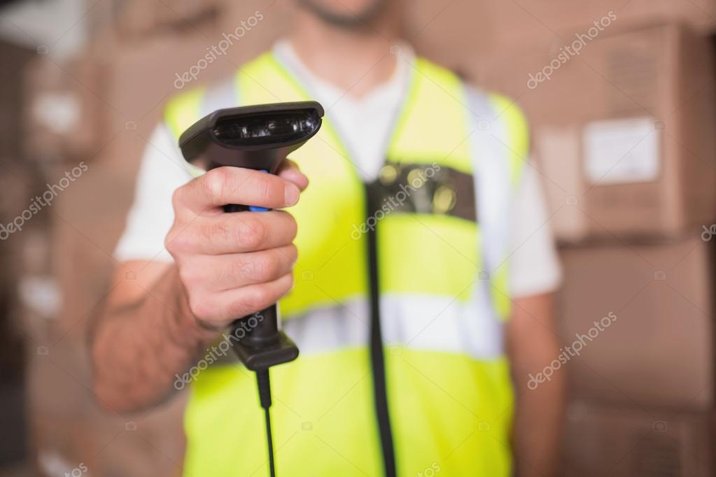 Worker holding scanner Stock Photo by ©Wavebreakmedia 81728066