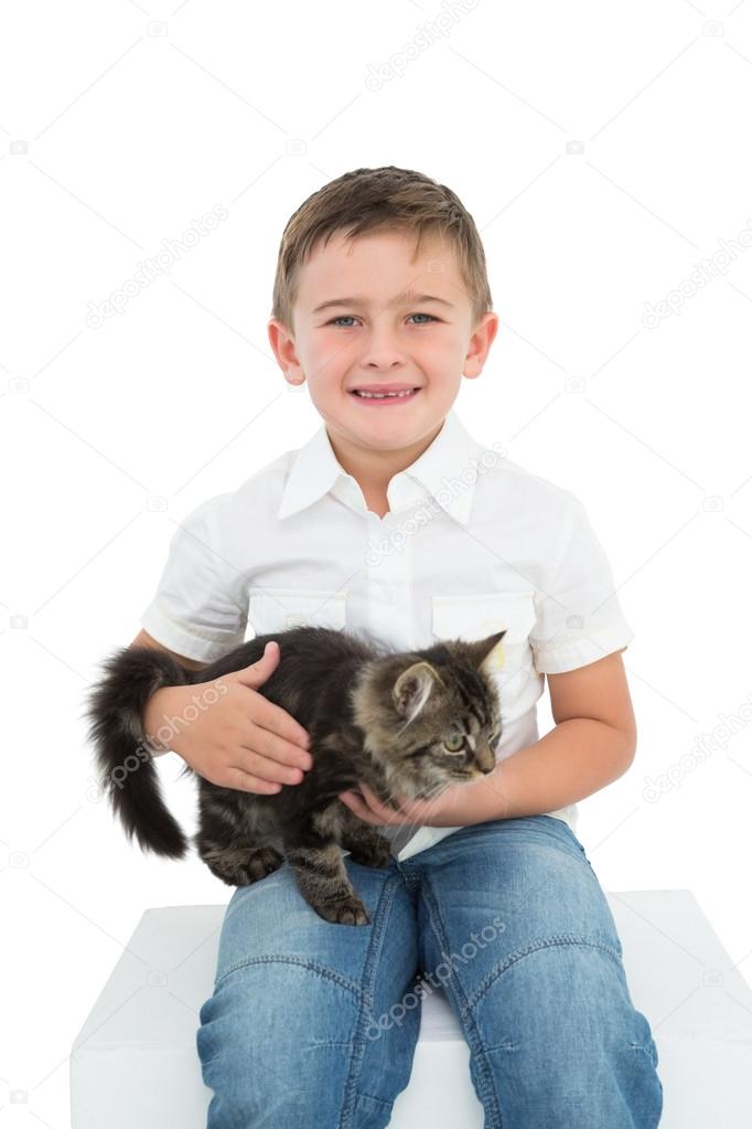 Boy sitting cuddling grey kitten Stock Photo by ©Wavebreakmedia 81728512