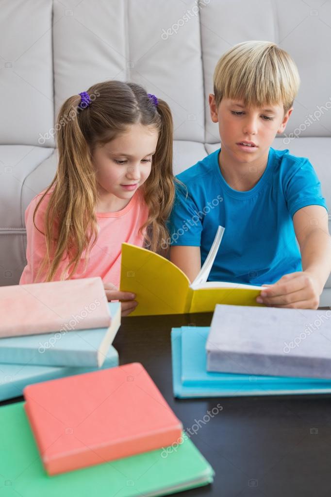 Siblings reading books on floor Stock Photo by ©Wavebreakmedia 81730664