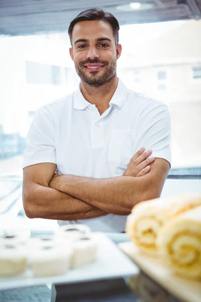 Smiling server in apron arm crossed - Stock Image - Everypixel