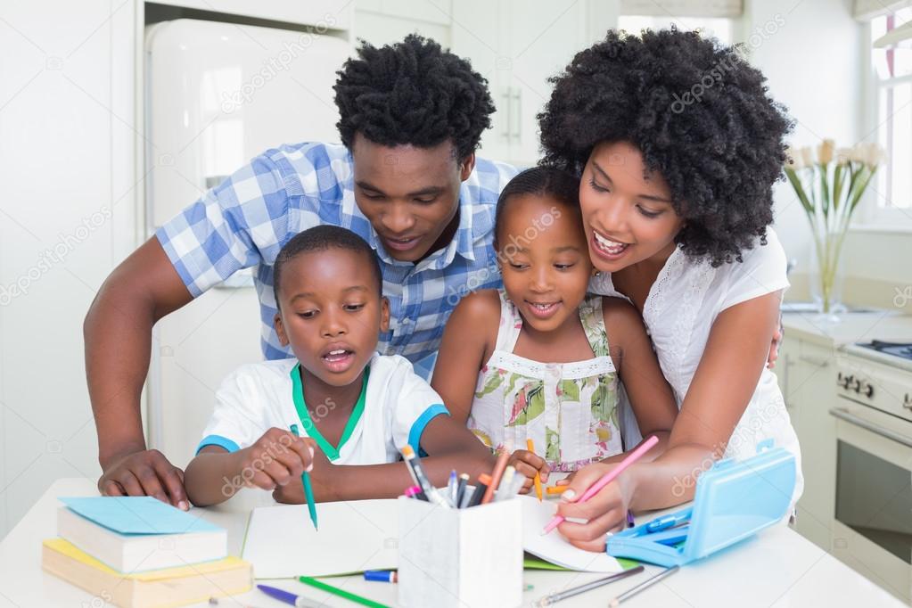 Happy parents helping children with homework Stock Photo by ...