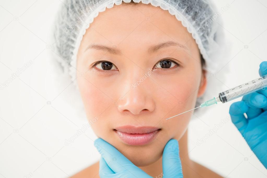 Relaxed model having botox injection Stock Photo by ©Wavebreakmedia ...