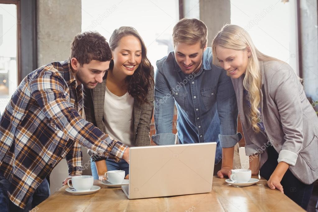 Smiling friends standing and pointing on laptop screen — Stock Photo ...