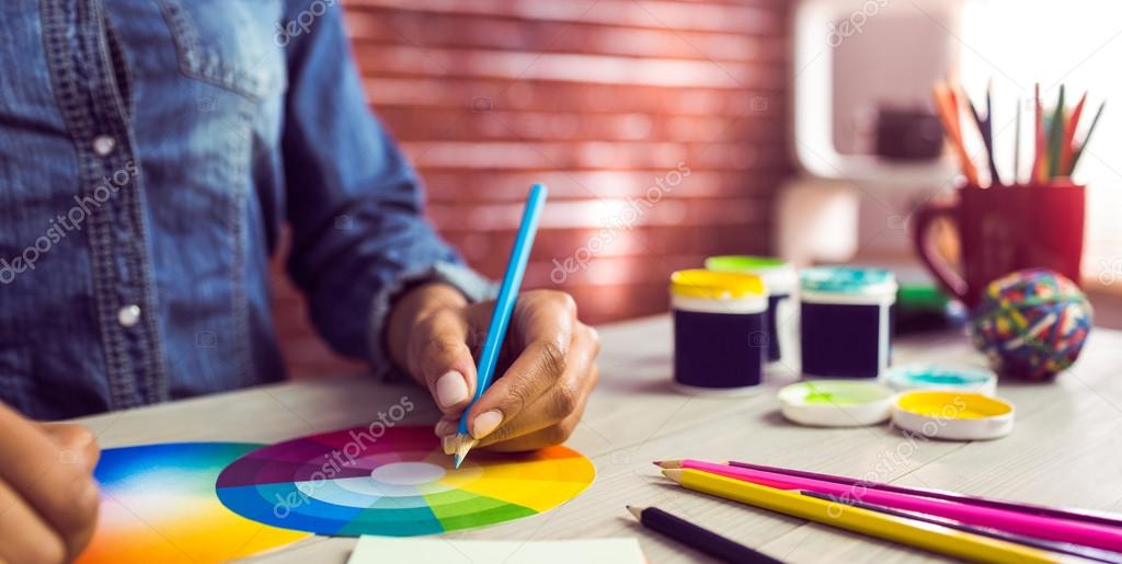 Designer drawing on colour chart Stock Photo by ©Wavebreakmedia 84469708