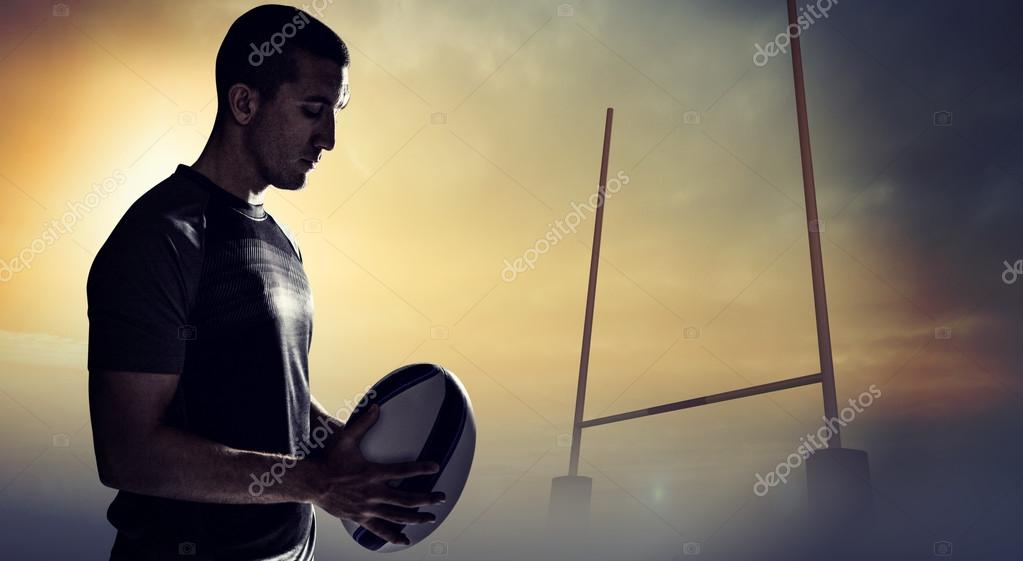 Player thinking while holding ball Stock Photo by ©Wavebreakmedia 84681328