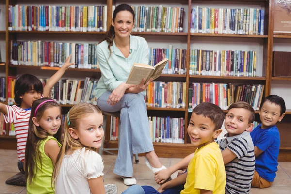 Teacher and kids reading book in library Stock Photo by ©Wavebreakmedia ...