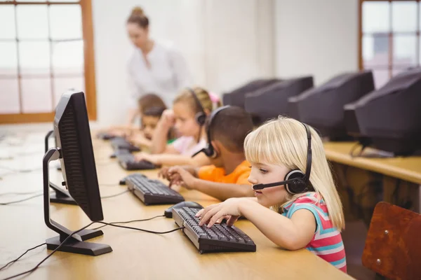 Students using computers in classroom - Stock Image - Everypixel