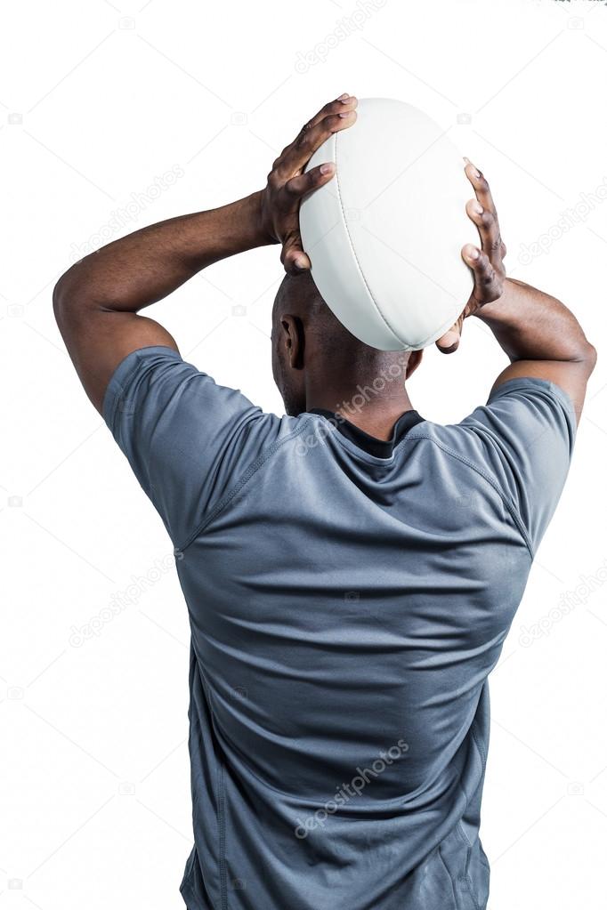 Sportsman throwing rugby ball Stock Photo by ©Wavebreakmedia 84889838