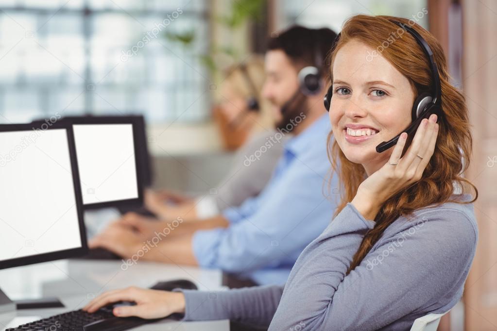 Smiling female operator with colleagues Stock Photo by ©Wavebreakmedia ...