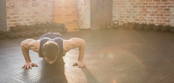 Handsome man doing wide arm push ups - Stock Image - Everypixel