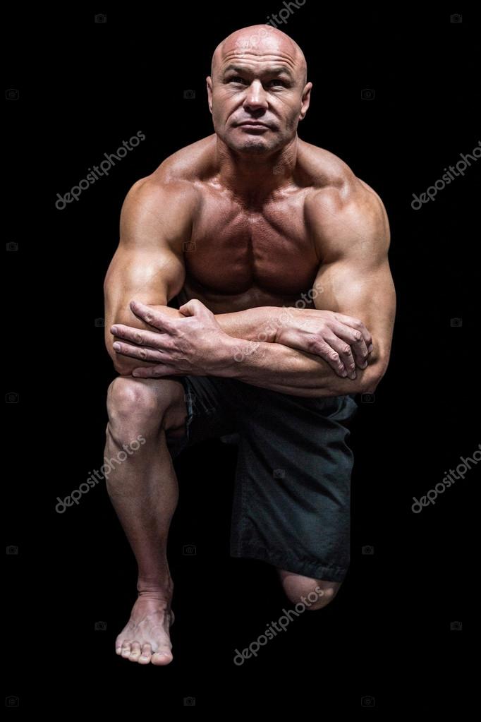 Muscular man kneeling down — Stock Photo © Wavebreakmedia #84915012