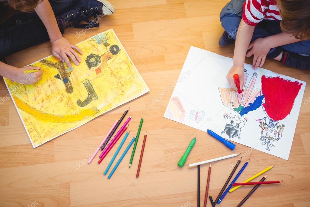 Two kids drawing together on sheets Stock Photo by ©Wavebreakmedia 90556114
