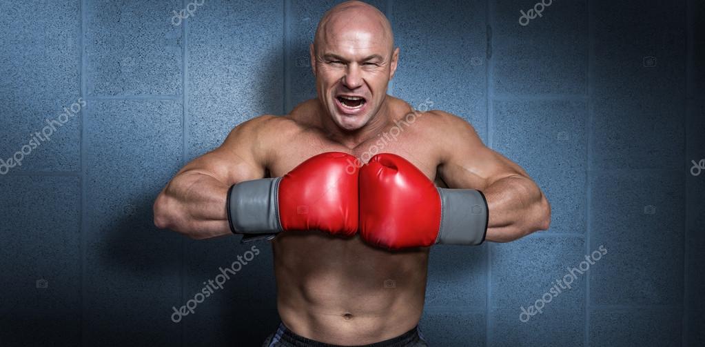 Angry bald boxer with punching gloves Stock Photo by ©Wavebreakmedia ...