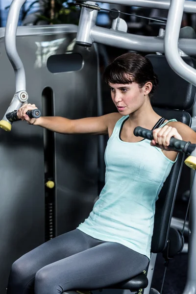 Fit woman using exercise machine - Stock Image - Everypixel