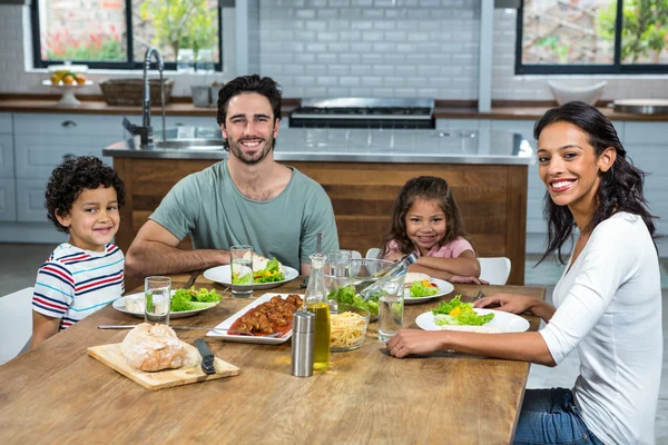 Happy family eating together in the kitchen - Stock Image - Everypixel